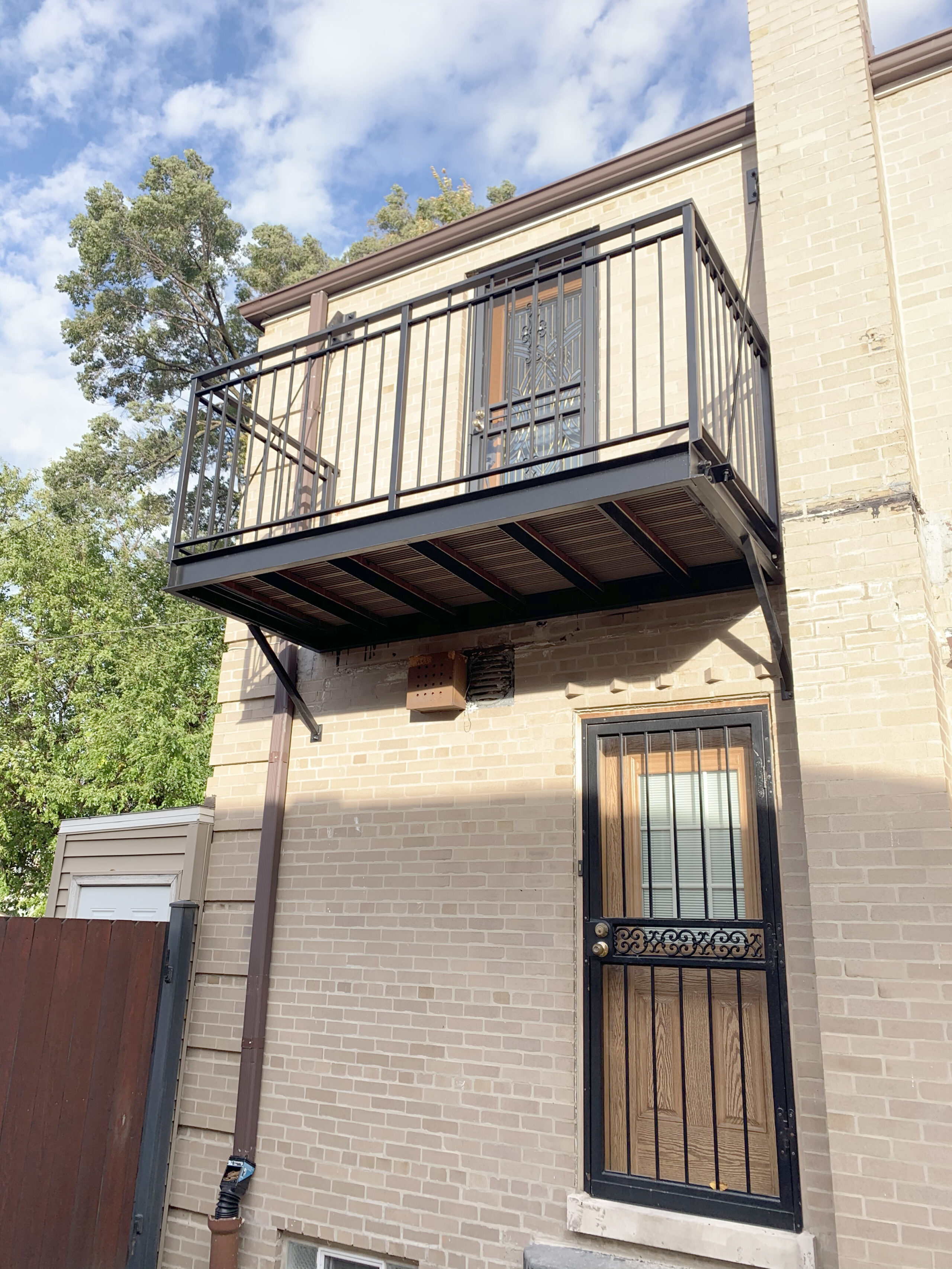 Traditional wrought iron & wood balconies painted satin black in ...